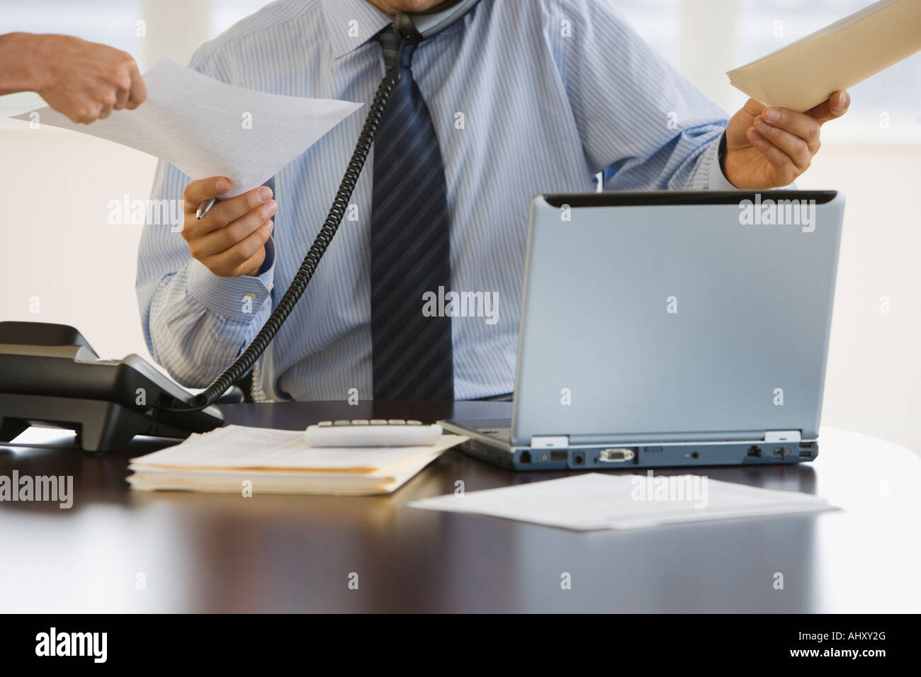 Busy businessman at desk Stock Photo - Alamy
