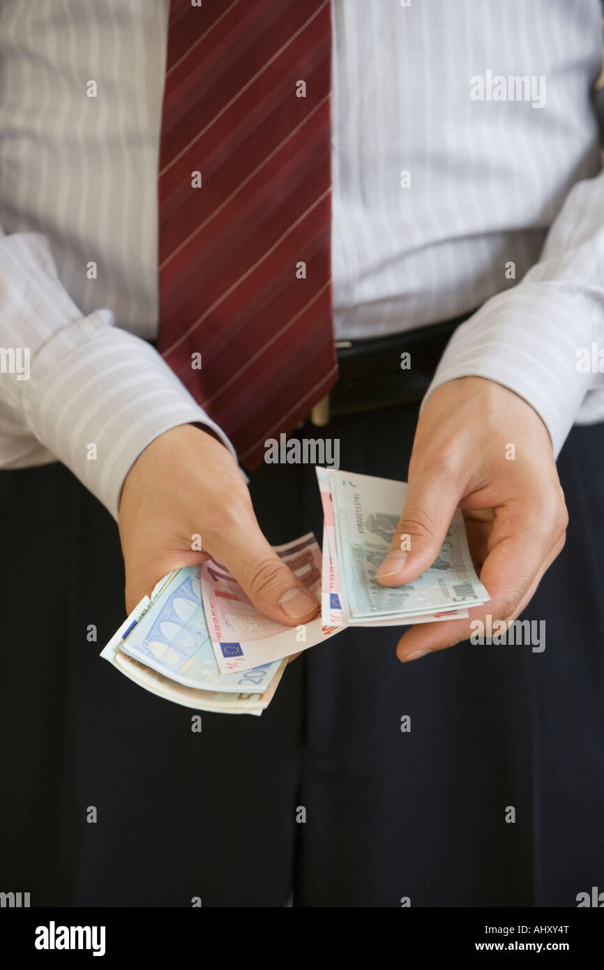 Businessman counting Euro banknotes Stock Photo - Alamy