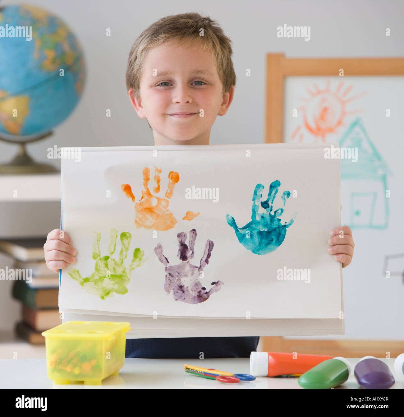 Boy holding handprint painting Stock Photo - Alamy