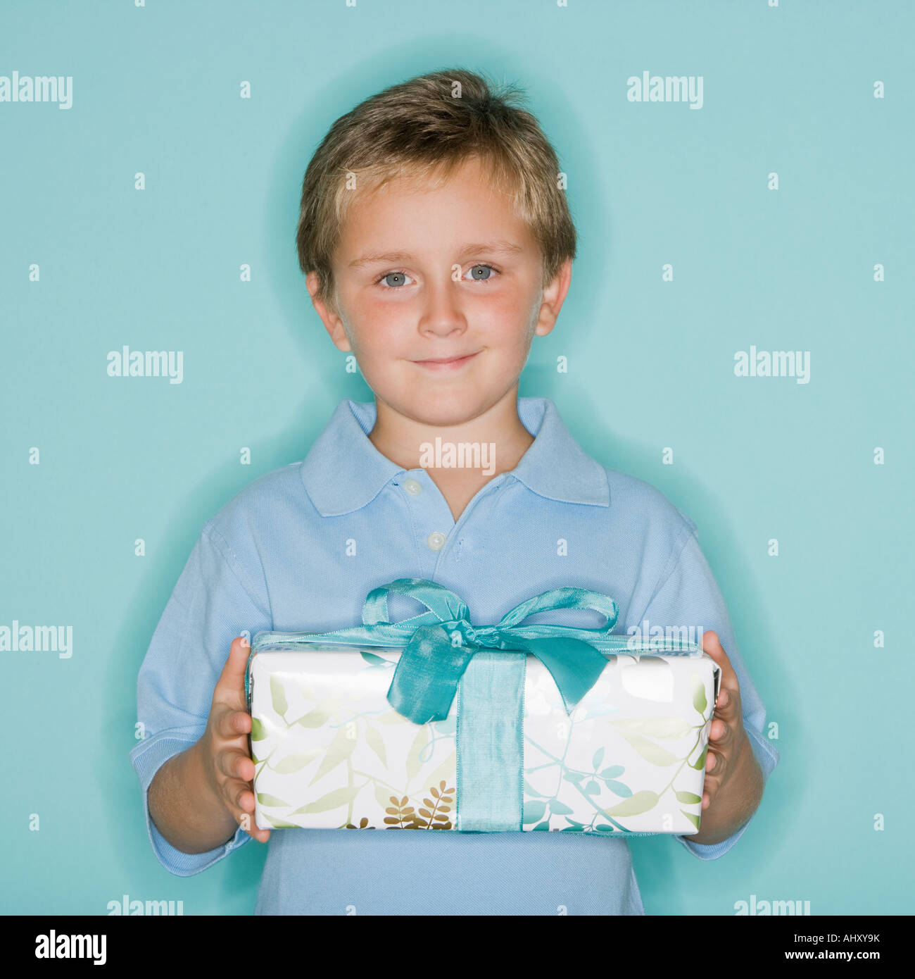 Boy holding gift Stock Photo - Alamy