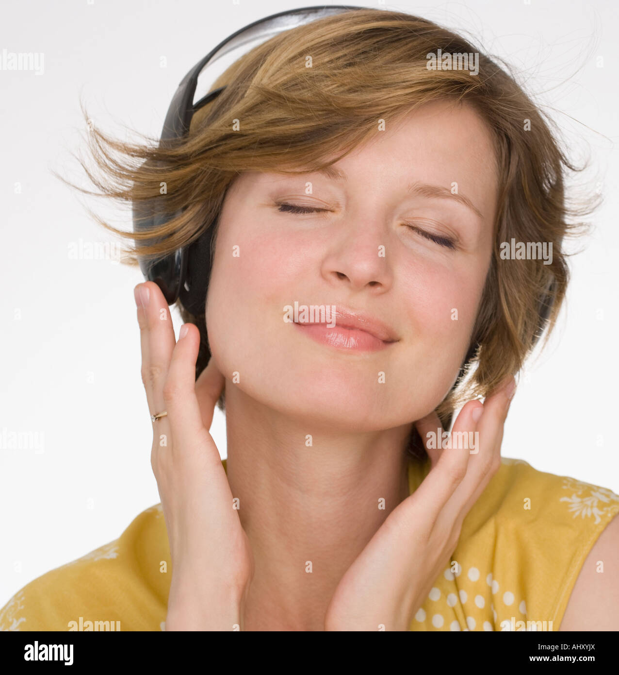 Woman listening to headphones Stock Photo - Alamy