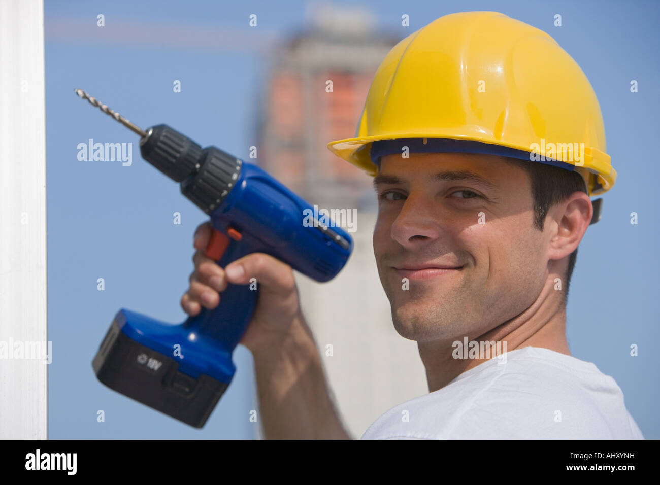 Construction worker holding cordless drill Stock Photo - Alamy