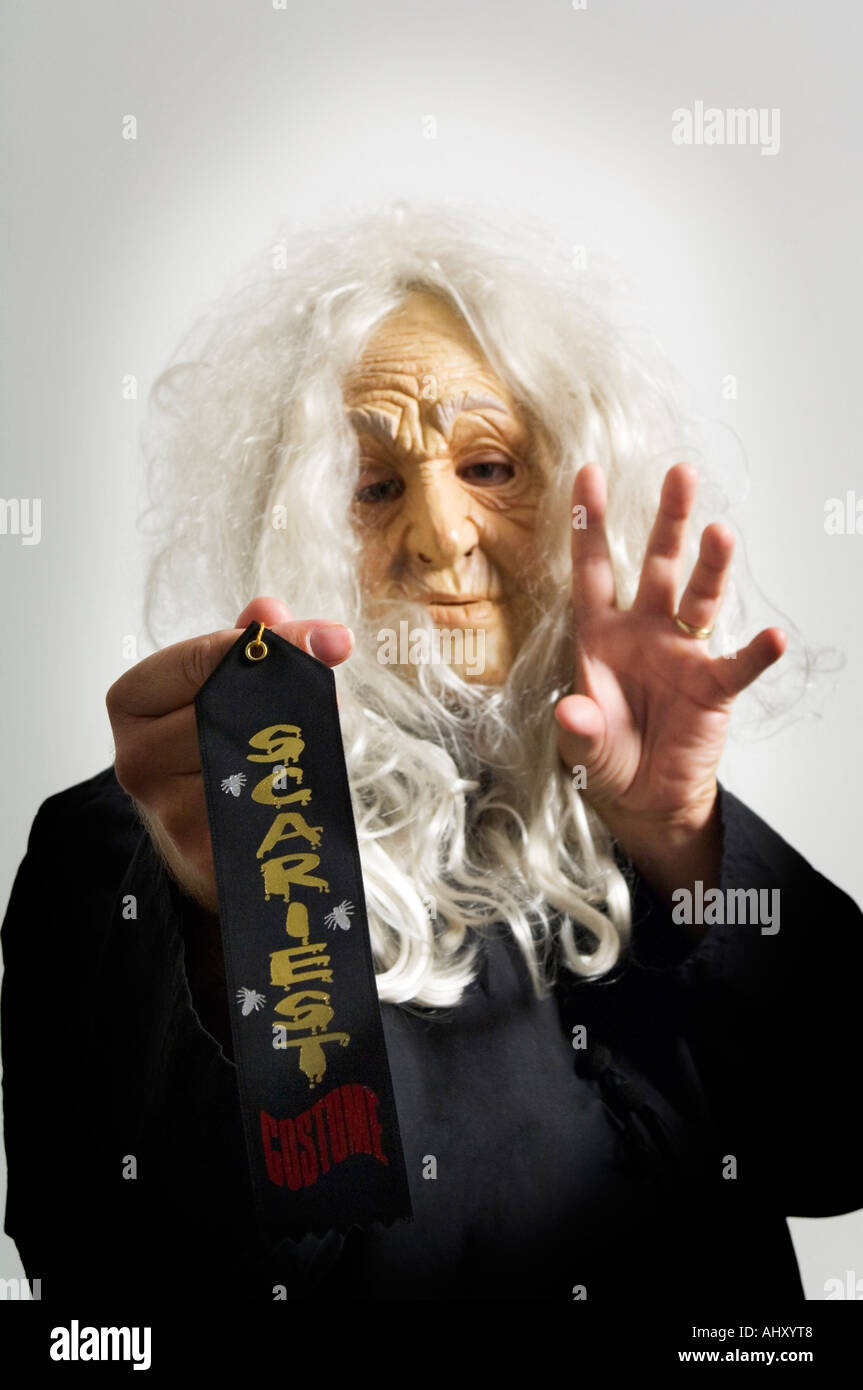 Witch holding scariest Halloween costume award Stock Photo - Alamy