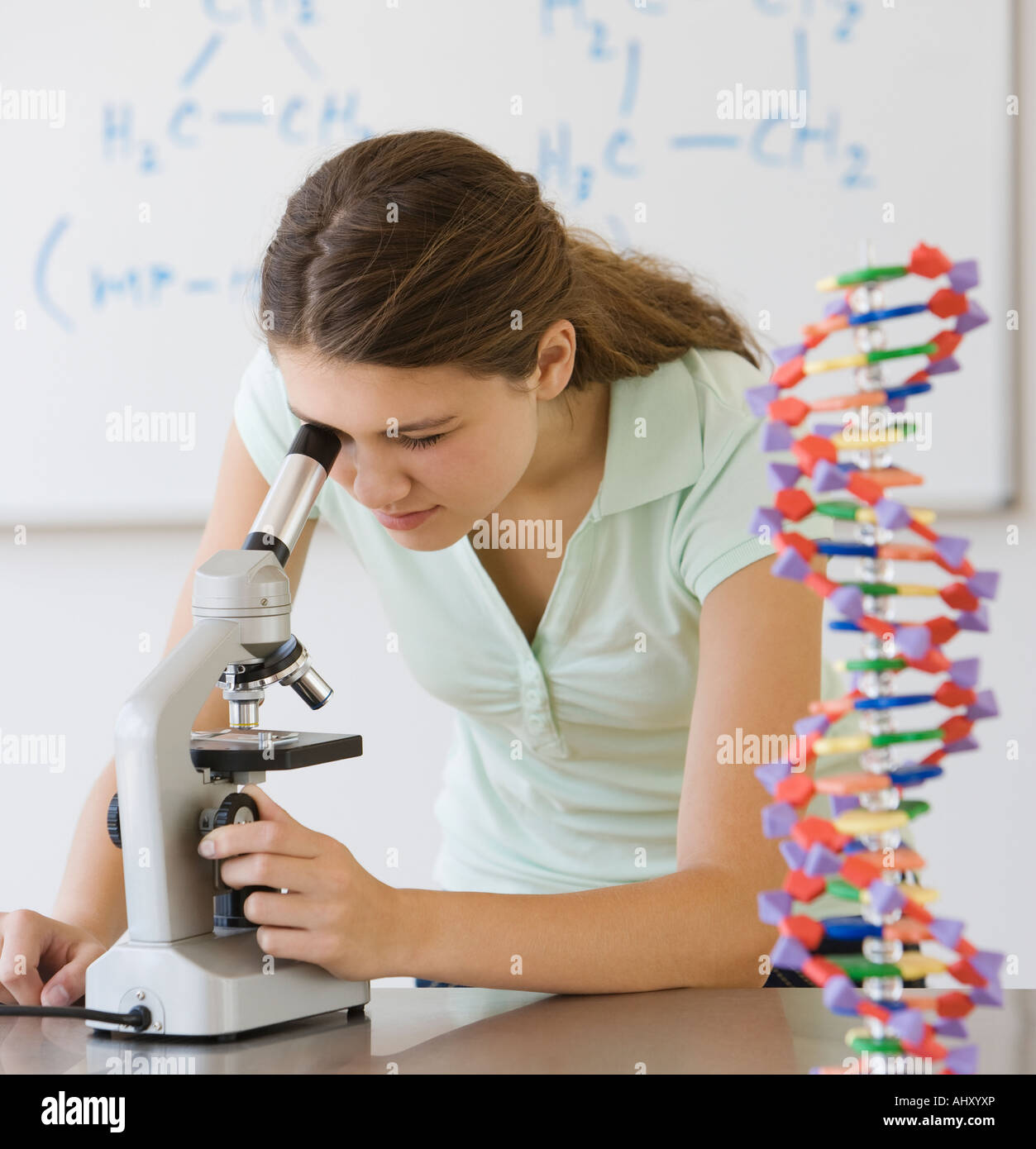 Girl using microscope Stock Photo - Alamy