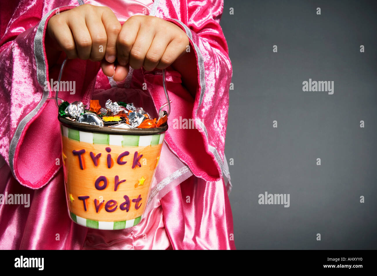 Girl holding Halloween trick or treat bucket Stock Photo - Alamy