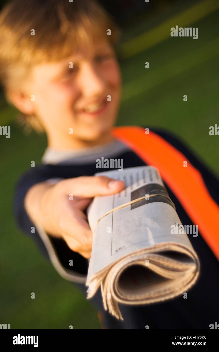 Newspaper carrier delivering newspaper Stock Photo - Alamy