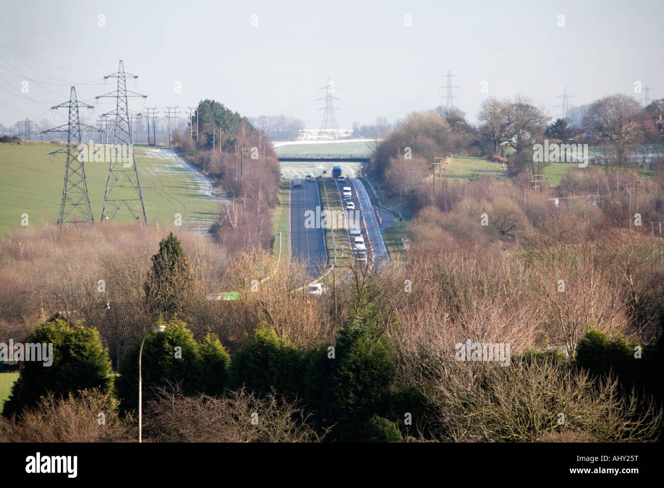 Countryside road pylon field Stock Photo - Alamy