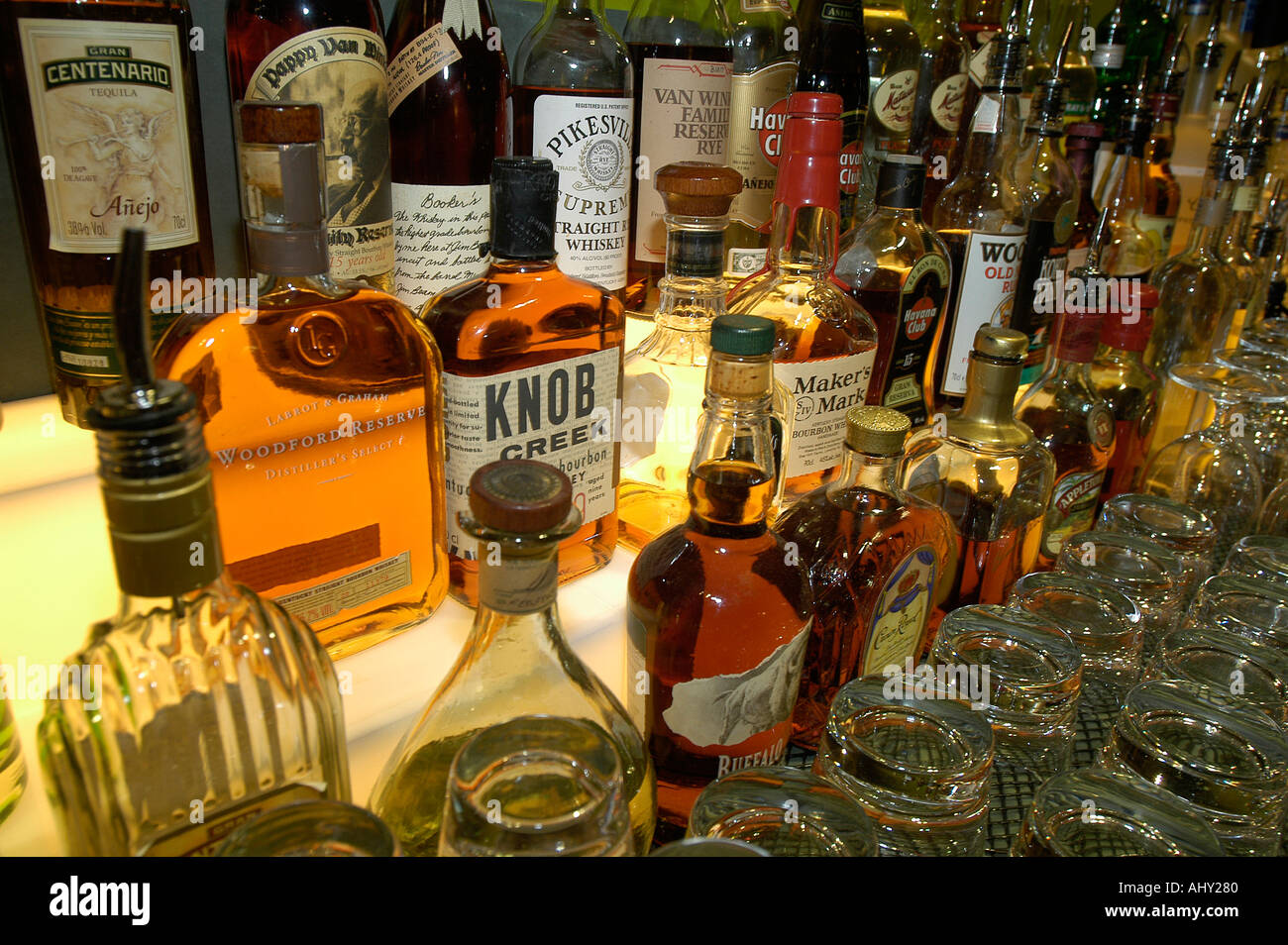 Bottles of alcohol lined up on bar Stock Photo - Alamy