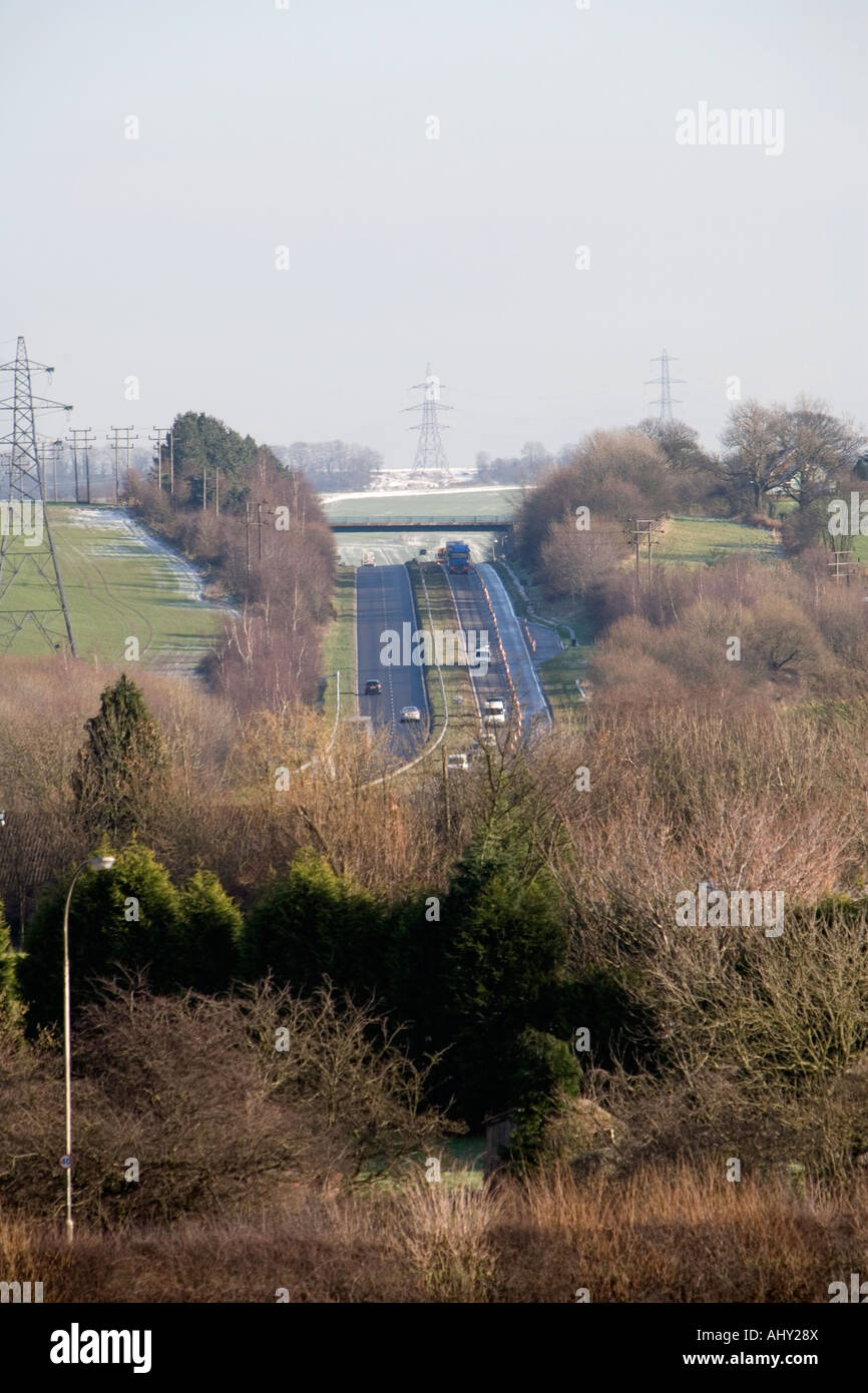 Countryside road pylon field Stock Photo - Alamy