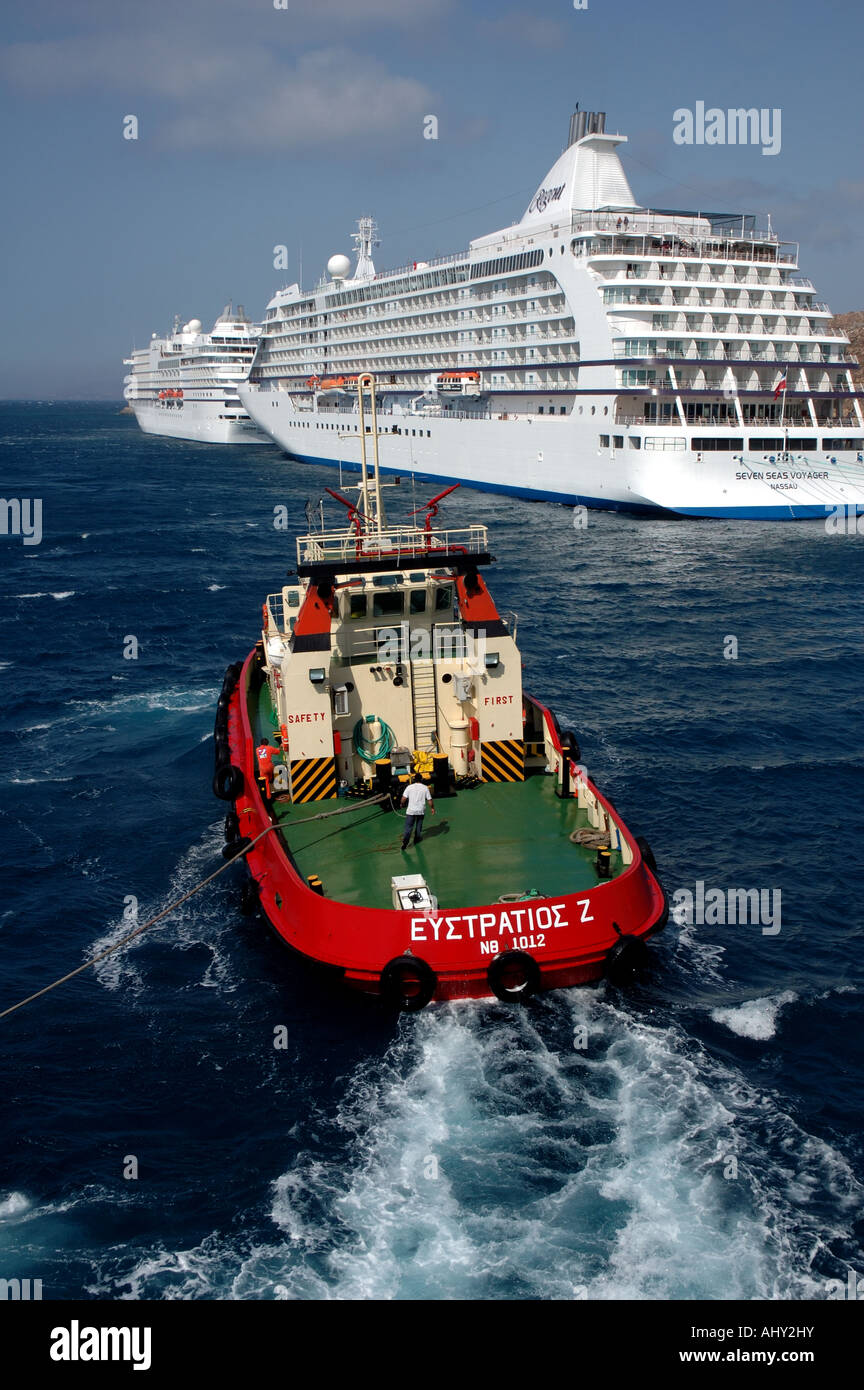 Tug boat operating in Mykonos, Greece, with two Regent cruise ships in ...