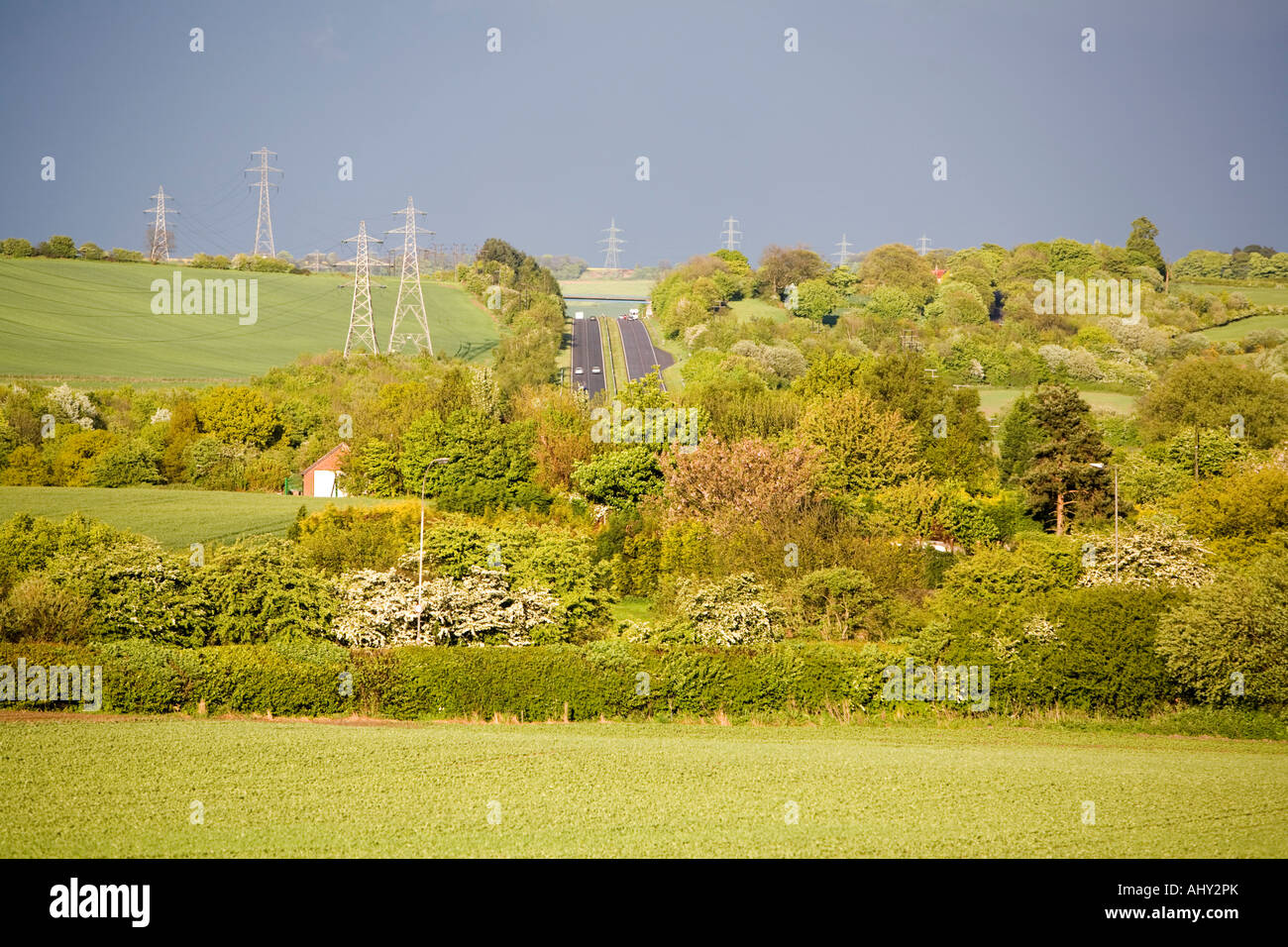 Countryside road pylon field Stock Photo - Alamy