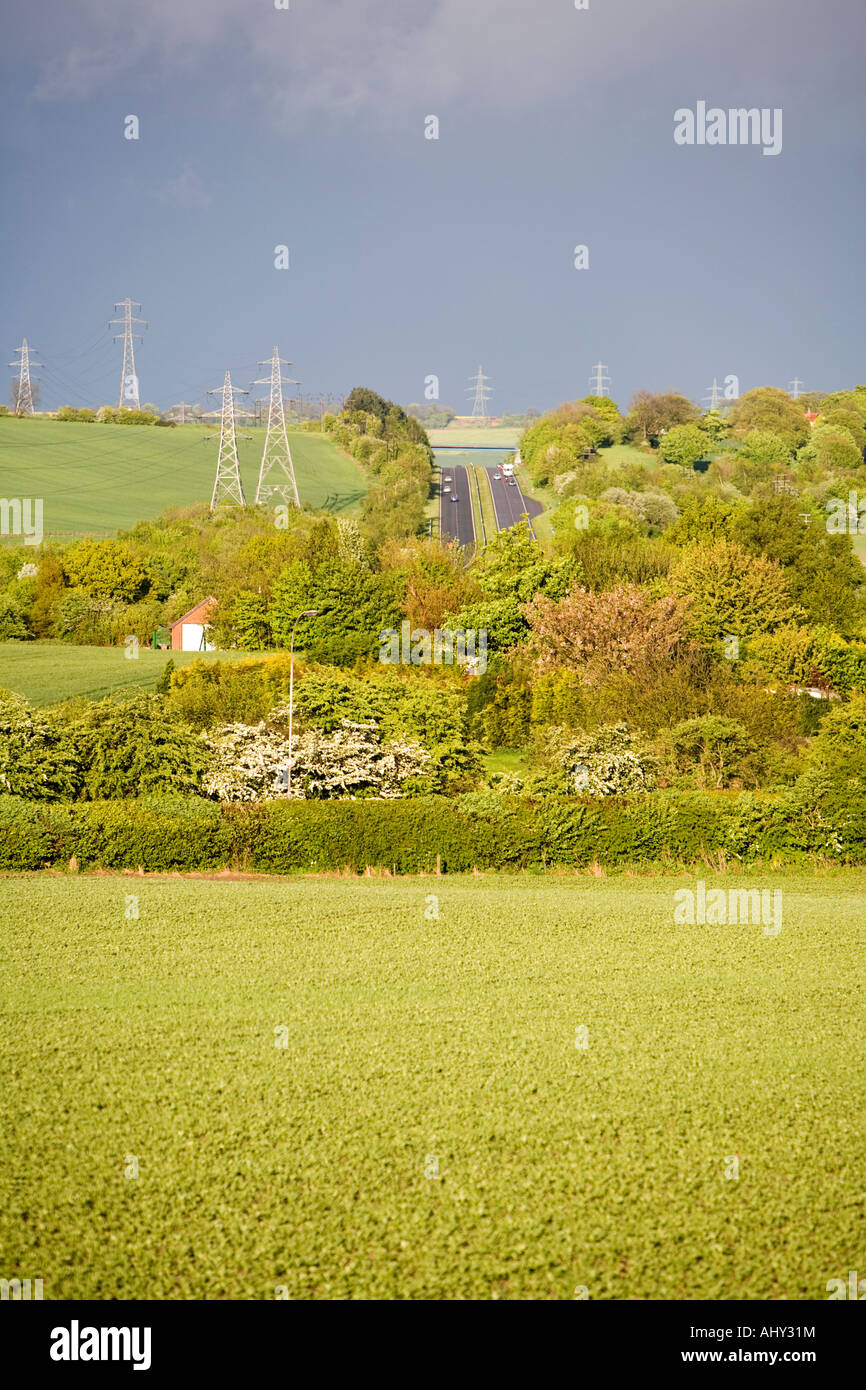 Countryside road pylon field Stock Photo - Alamy