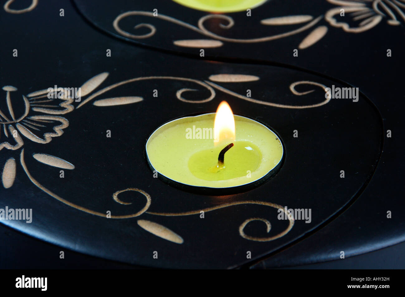 yellow candle on fire closeup Stock Photo - Alamy