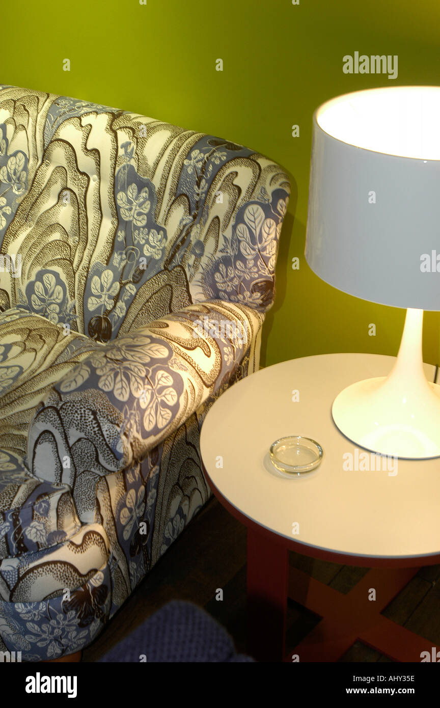 Patterned sofa edge with table and light Stock Photo - Alamy