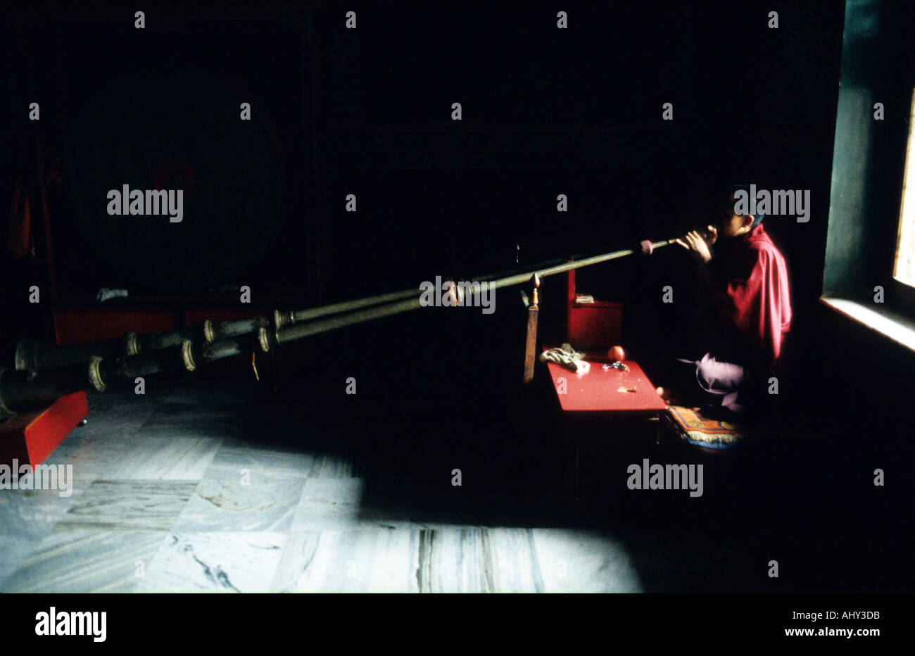 Tibetan monk playing ritual instrument in monastery prayer hall Stock ...