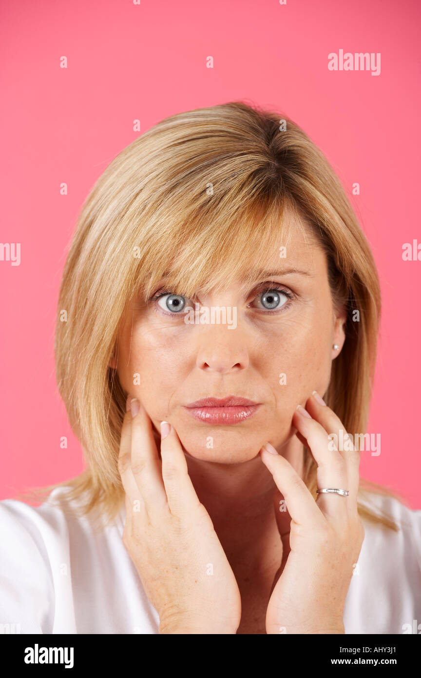 PORTRAIT OF ATTRACTIVE YOUNG BLONDE WOMAN WITH FACIAL EXPRESSION OF ...