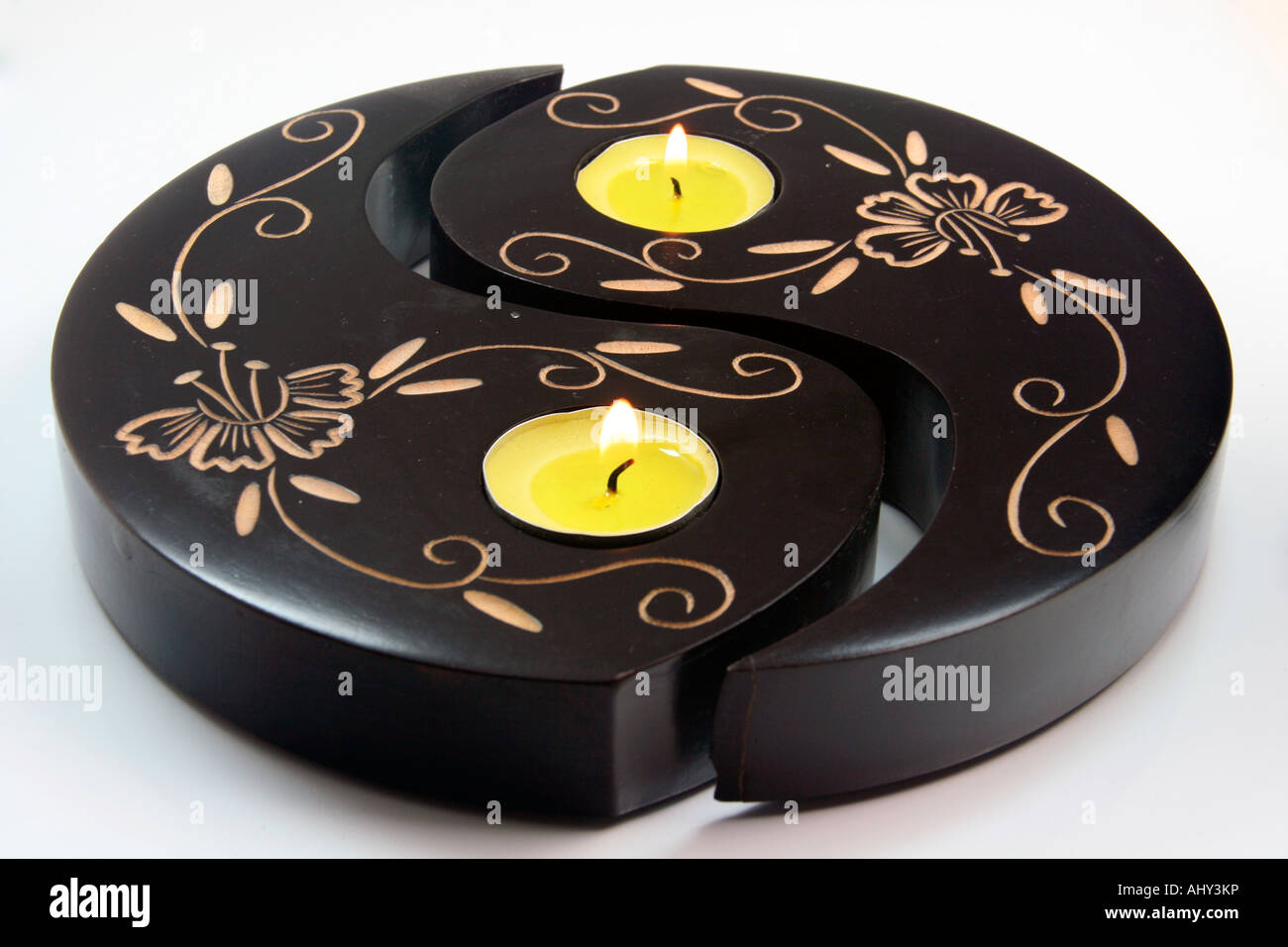 wooden ying yang with candes on fire Stock Photo - Alamy
