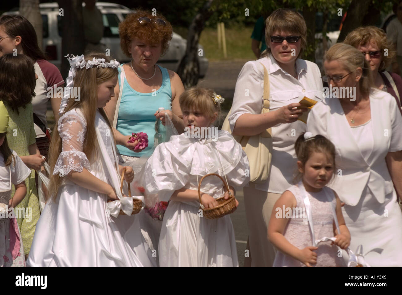 Polish Roman Catholic girls in white robes carrying flowers during ...