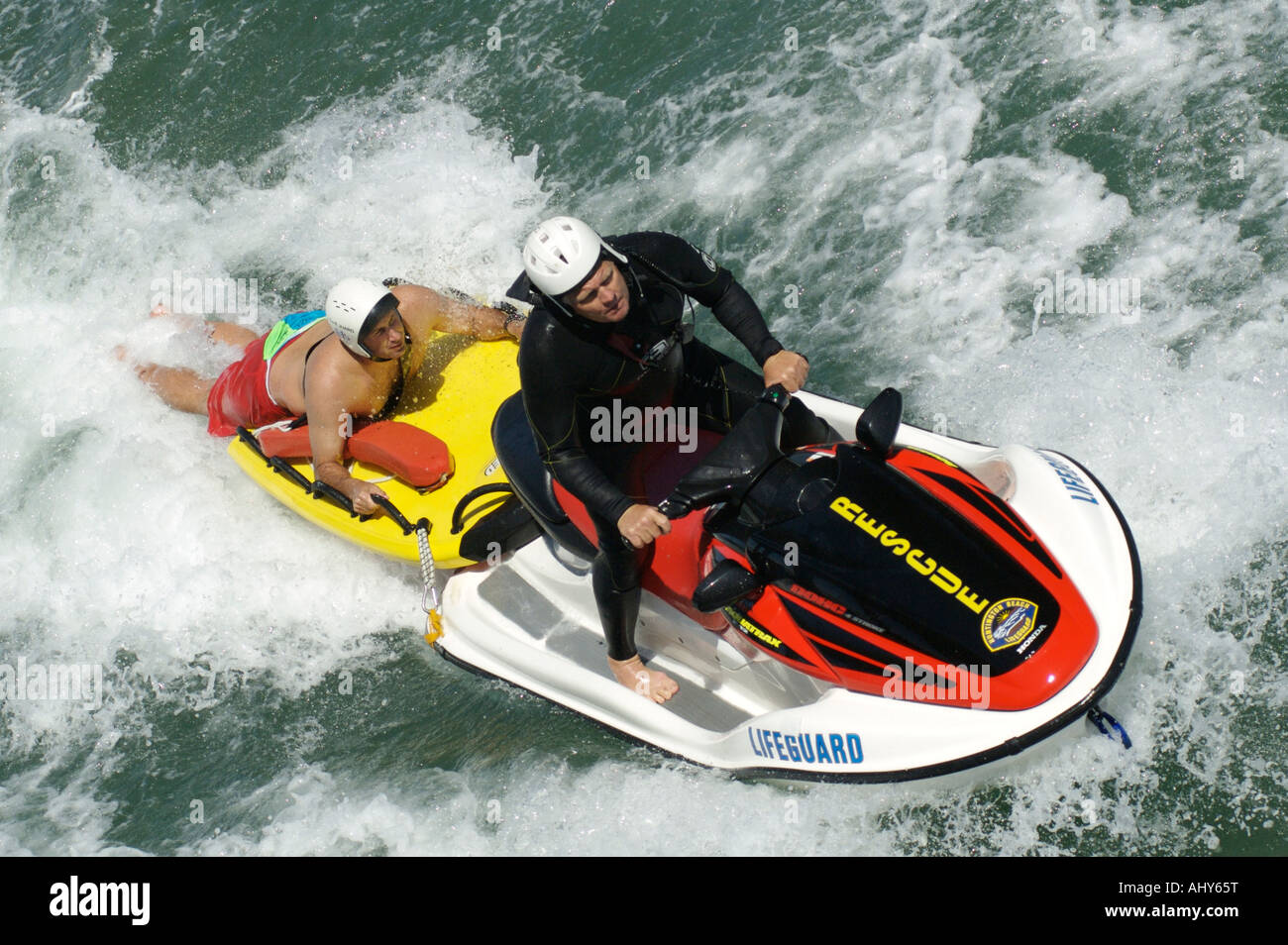 A life guard team demonstrates a surf rescue using a wave runner ...