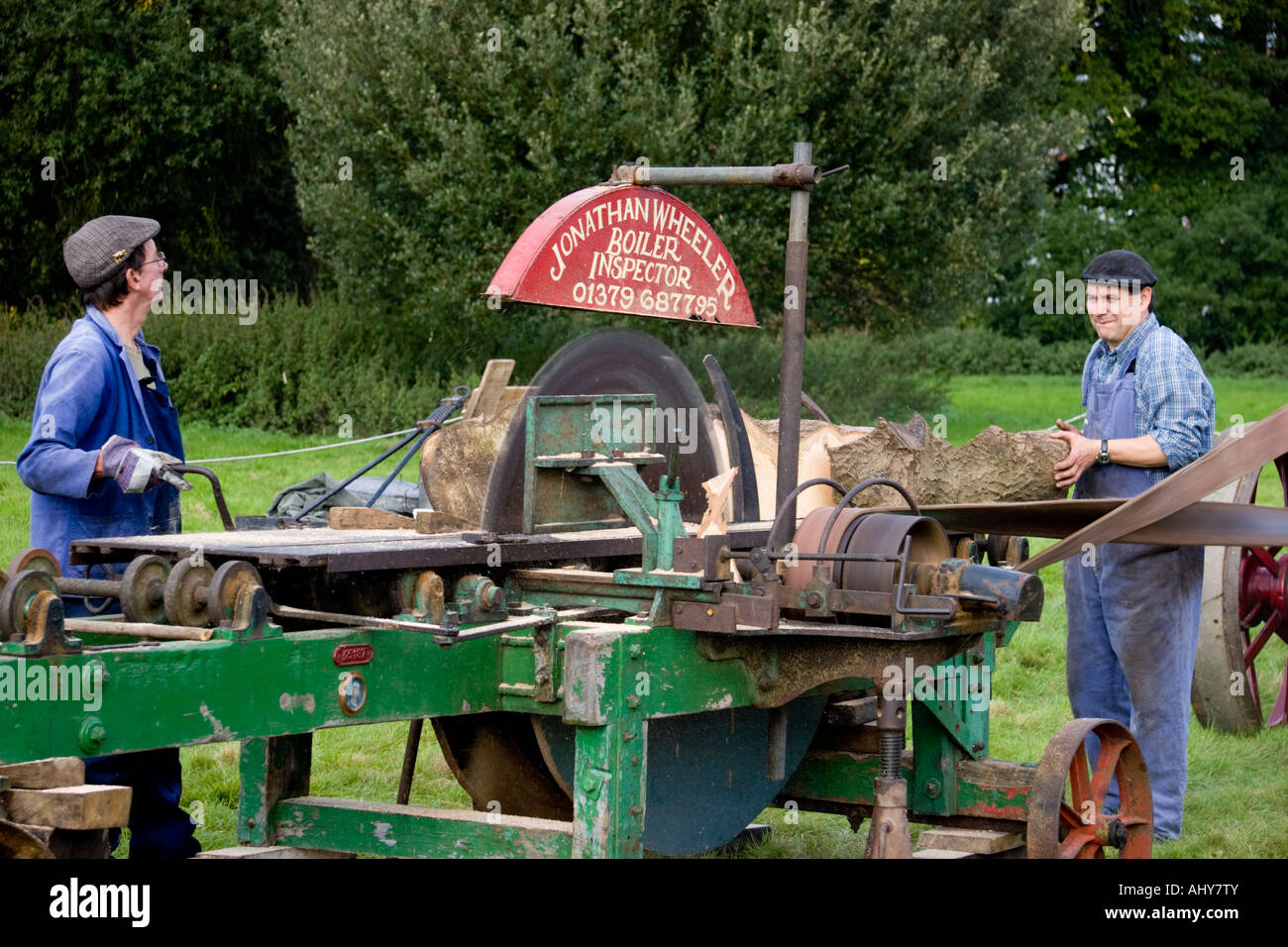 Men operating a steam powered wood saw Stock Photo - Alamy