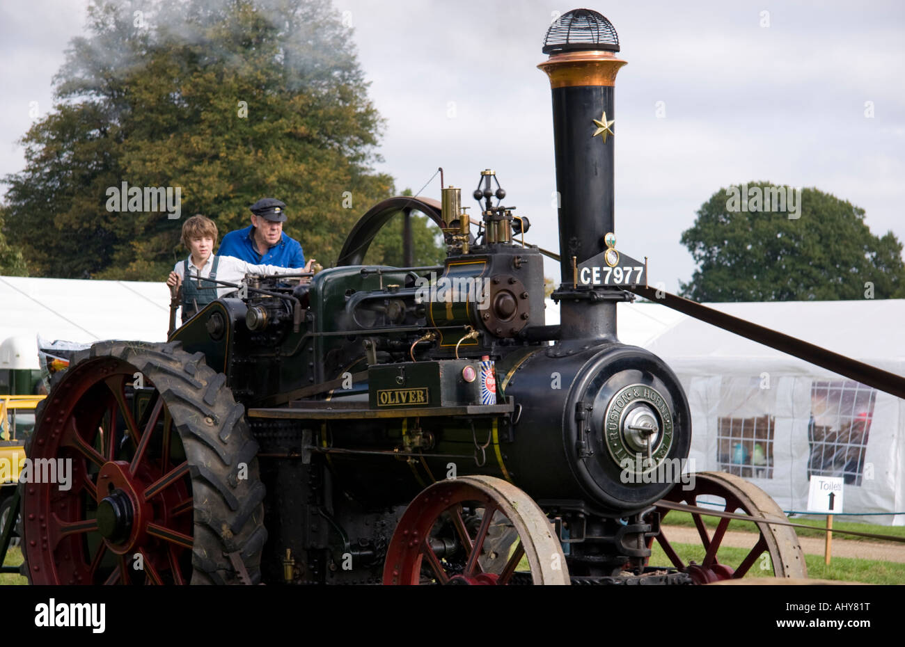 Elderly man and young boy operating a steam traction engine Stock Photo ...