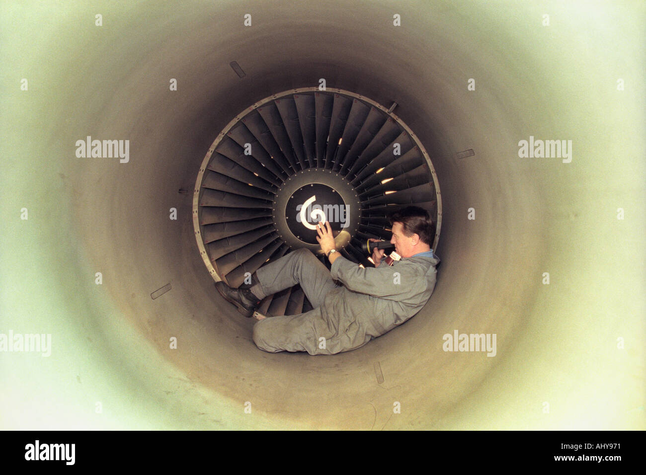 Aero jet engine engineer working on a CFM 563 jet engine at service ...