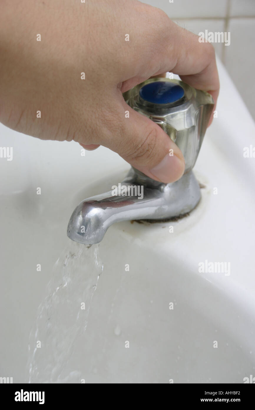 Hand turning tap hi-res stock photography and images - Alamy