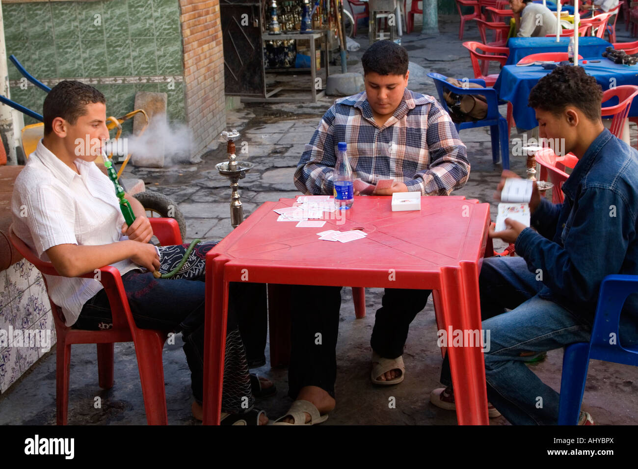 Tripoli, Libya. Young Men Playing Cards, Smoking Shisha in Cafe ...