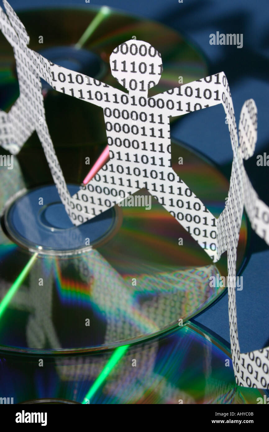 paper doll with binary numbers standing across compact discs Concept IT ...