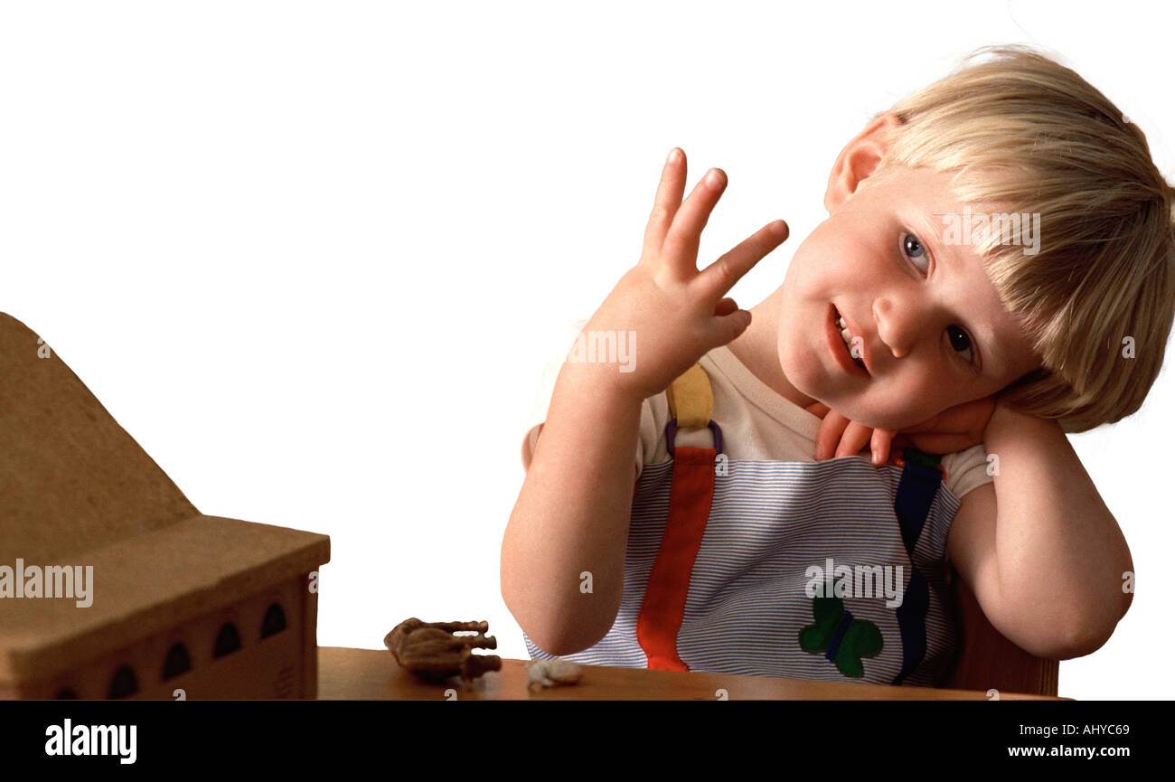 Young child photographed On a white background holding up three fingers ...