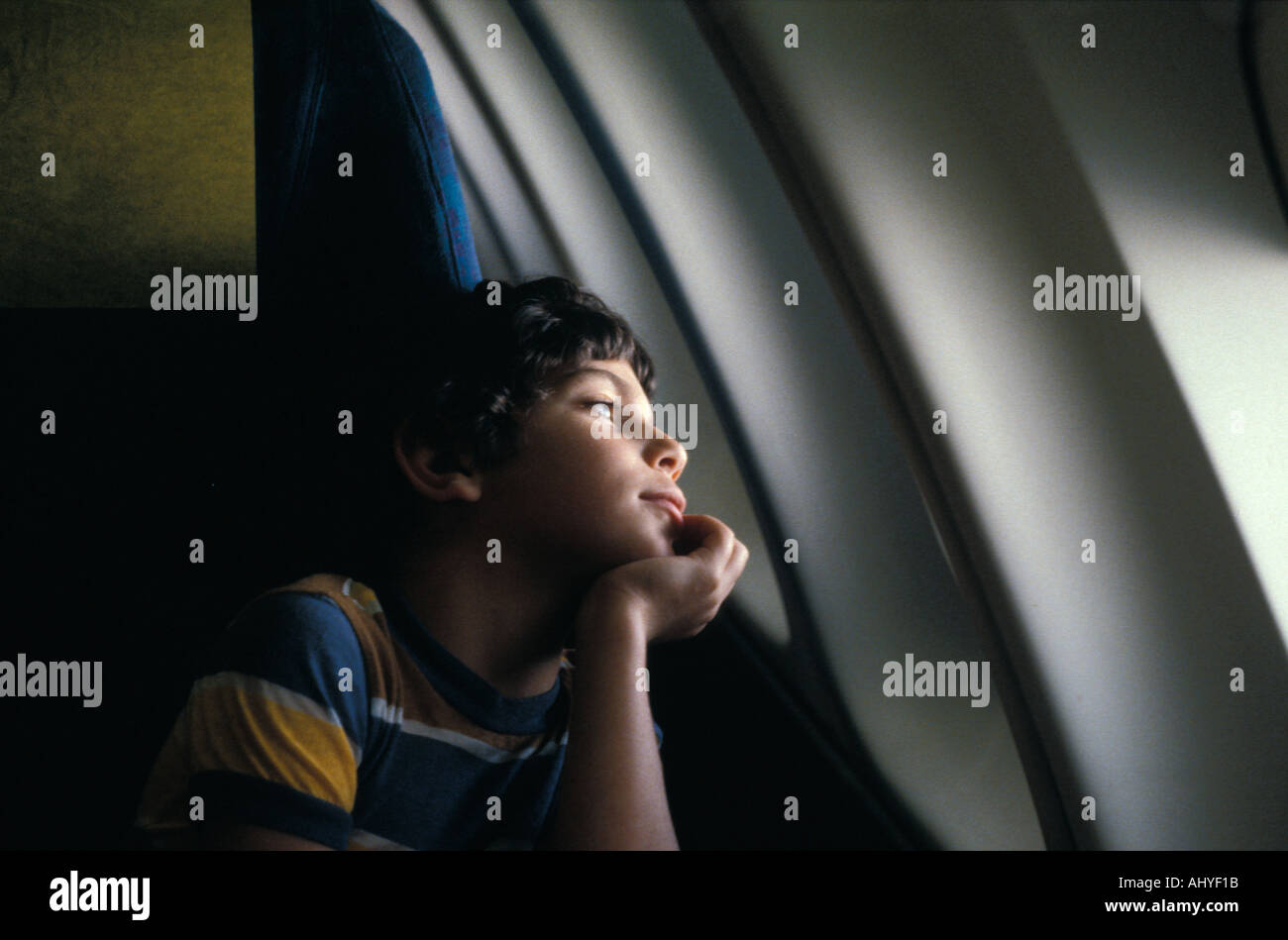 Young Caucasian boy gazing out plane window Stock Photo - Alamy