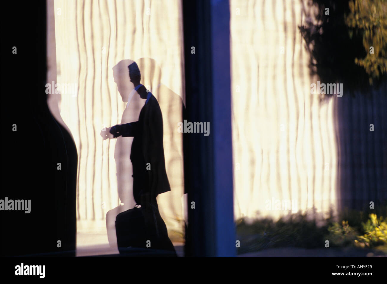 Silhouetted abstract reflection in office building window of ...