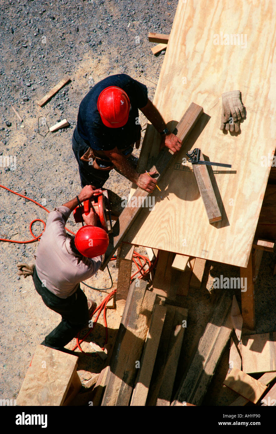 Overhead view of construction workers cutting lumber Stock Photo - Alamy