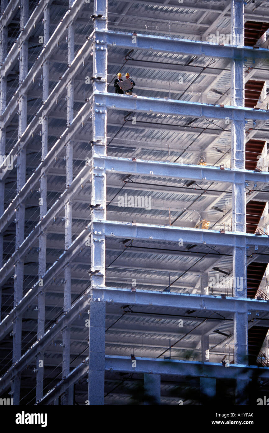 Architect and engineer looking at steel work for high rise office tower ...