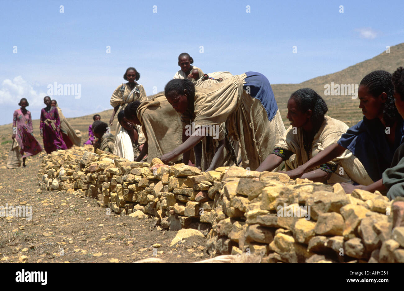 Women from a rural community terracing stoney land to prevent soil ...