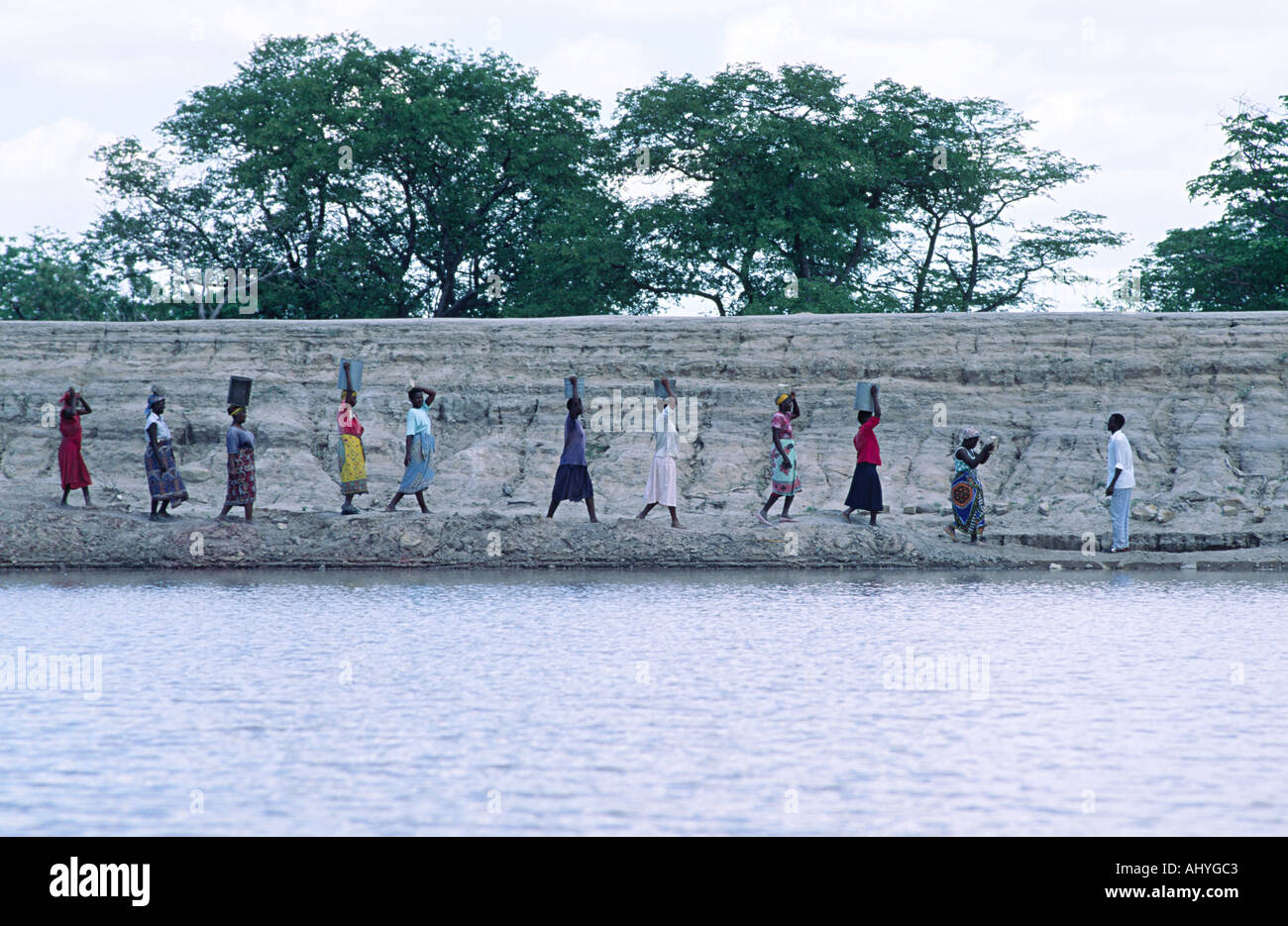 Women working on a community dam-building project to create a reservoir ...