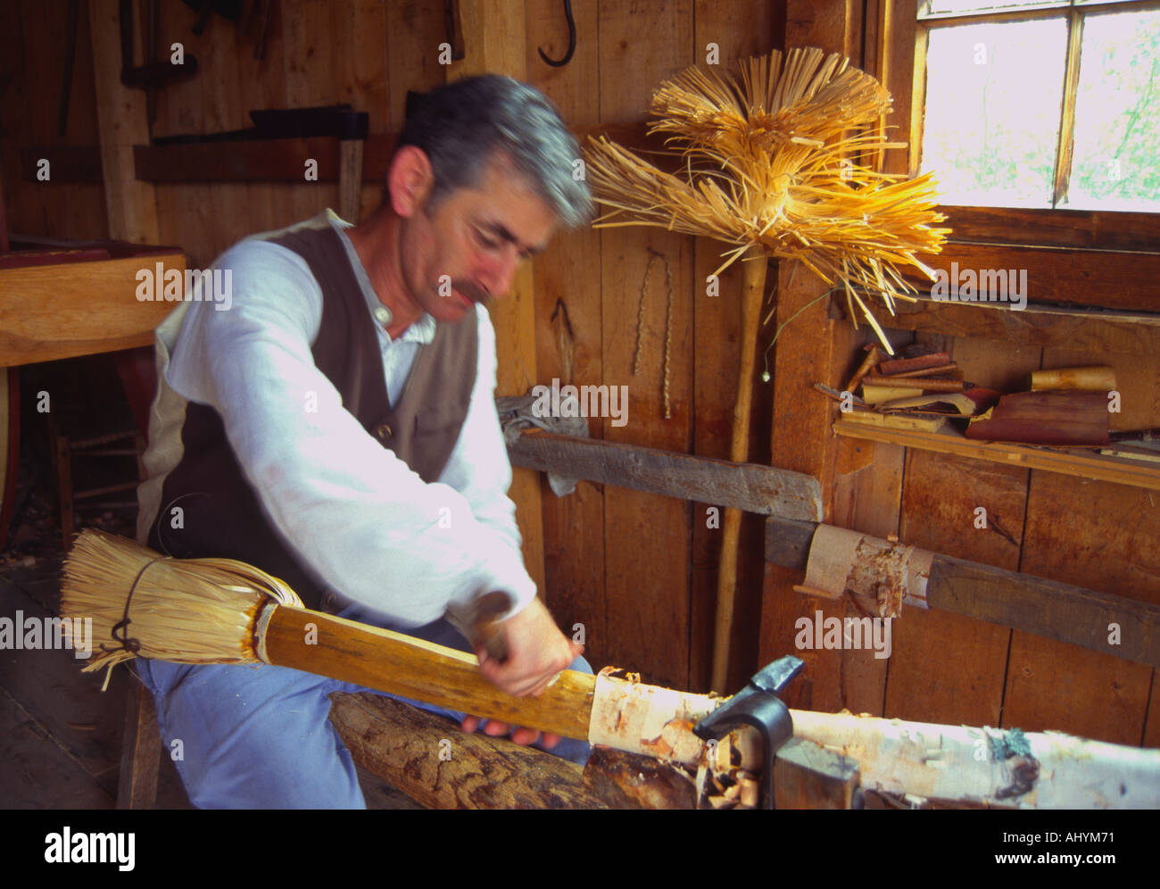 Canada New Brunswick Caraquet Acadian Historic Village man working on a ...