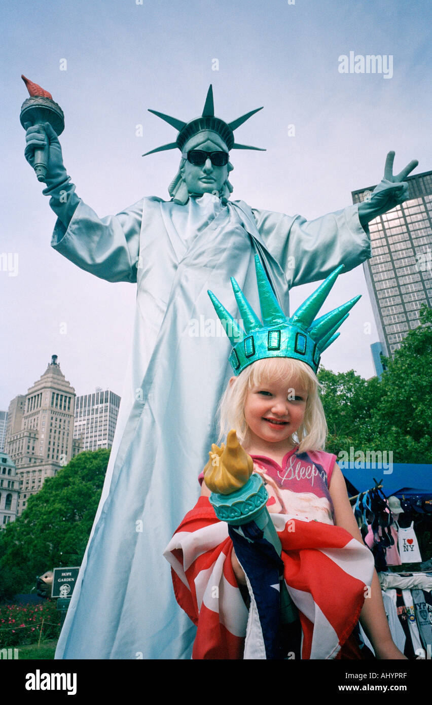 Little girl playing with an human version of Statue of Liberty Stock ...