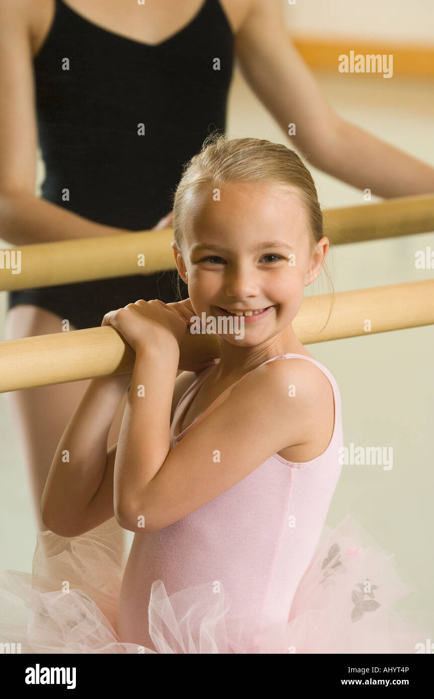Girl holding on to ballet bar Stock Photo - Alamy