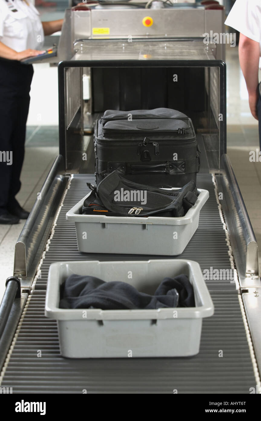Airport security worker checking baggage Stock Photo - Alamy