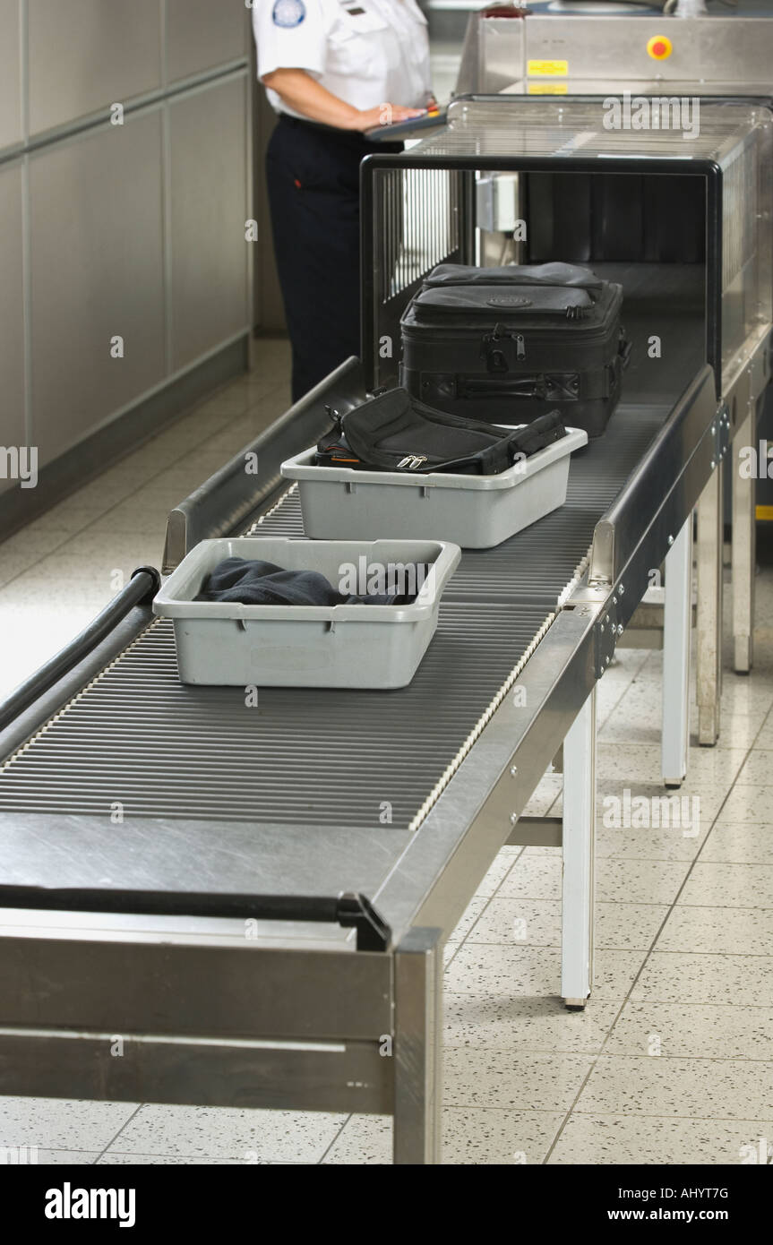 Airport security worker checking baggage Stock Photo - Alamy
