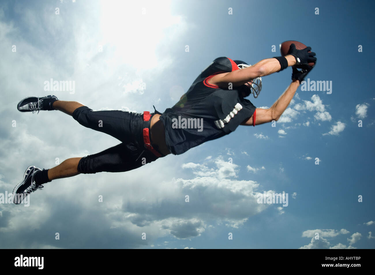 Low angle view of football player jumping Stock Photo - Alamy