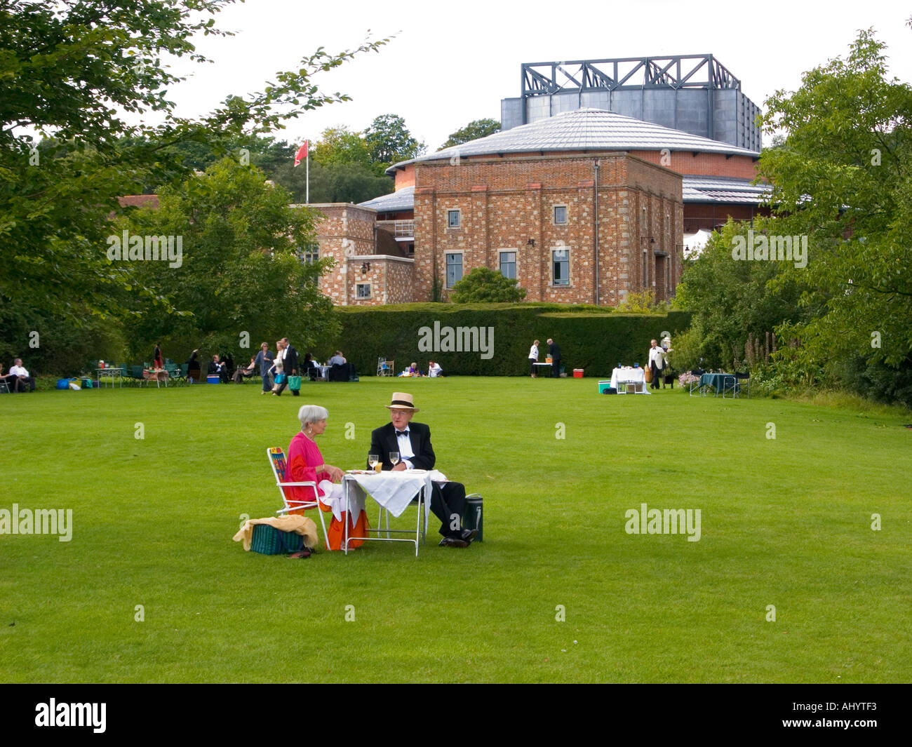 elderly couple dining in grounds of Glyndebourne opera house sussex ...
