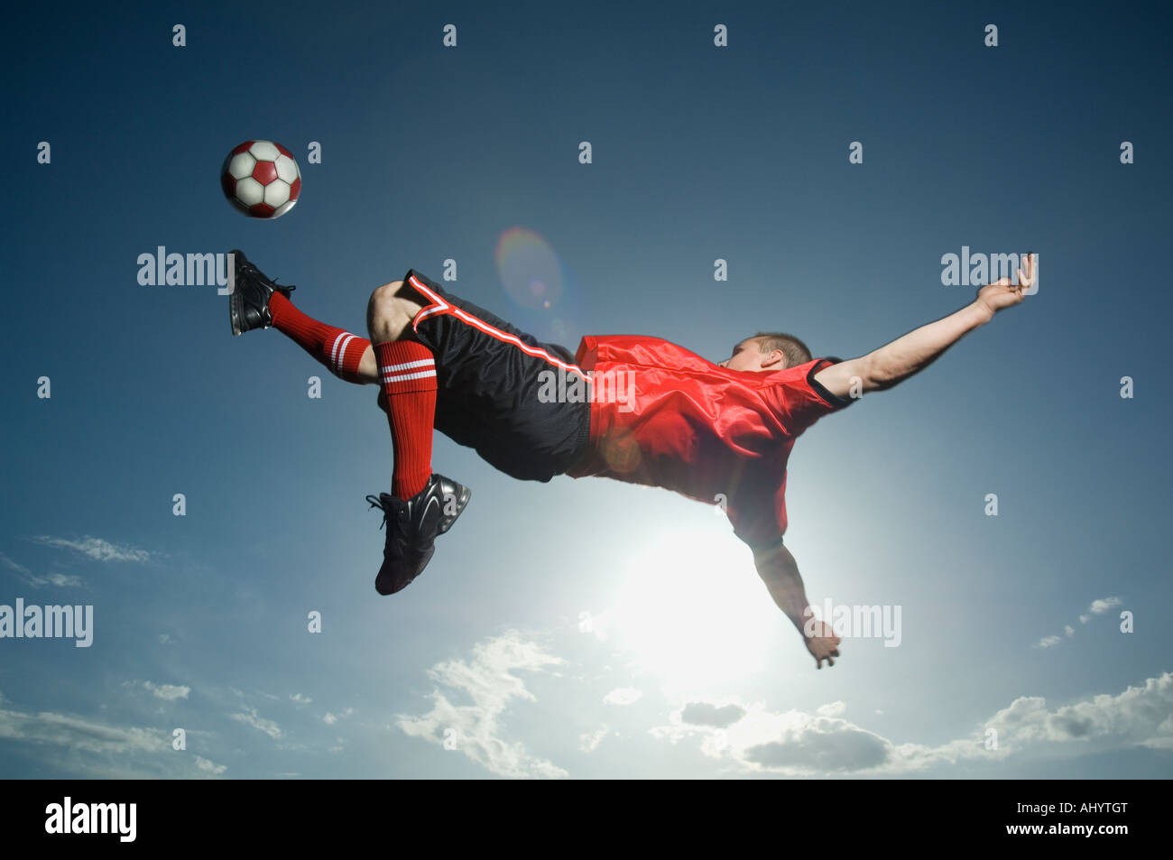 Low angle view of soccer player jumping Stock Photo - Alamy