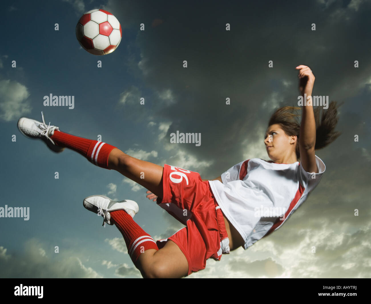 Low angle view of soccer player jumping Stock Photo - Alamy