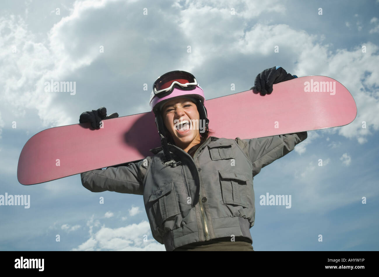 Snowboarder holding board on shoulders Stock Photo - Alamy