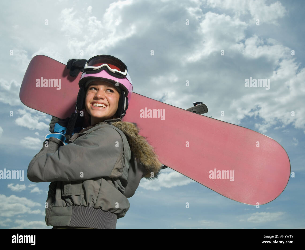 Snowboarder holding board on shoulder Stock Photo - Alamy
