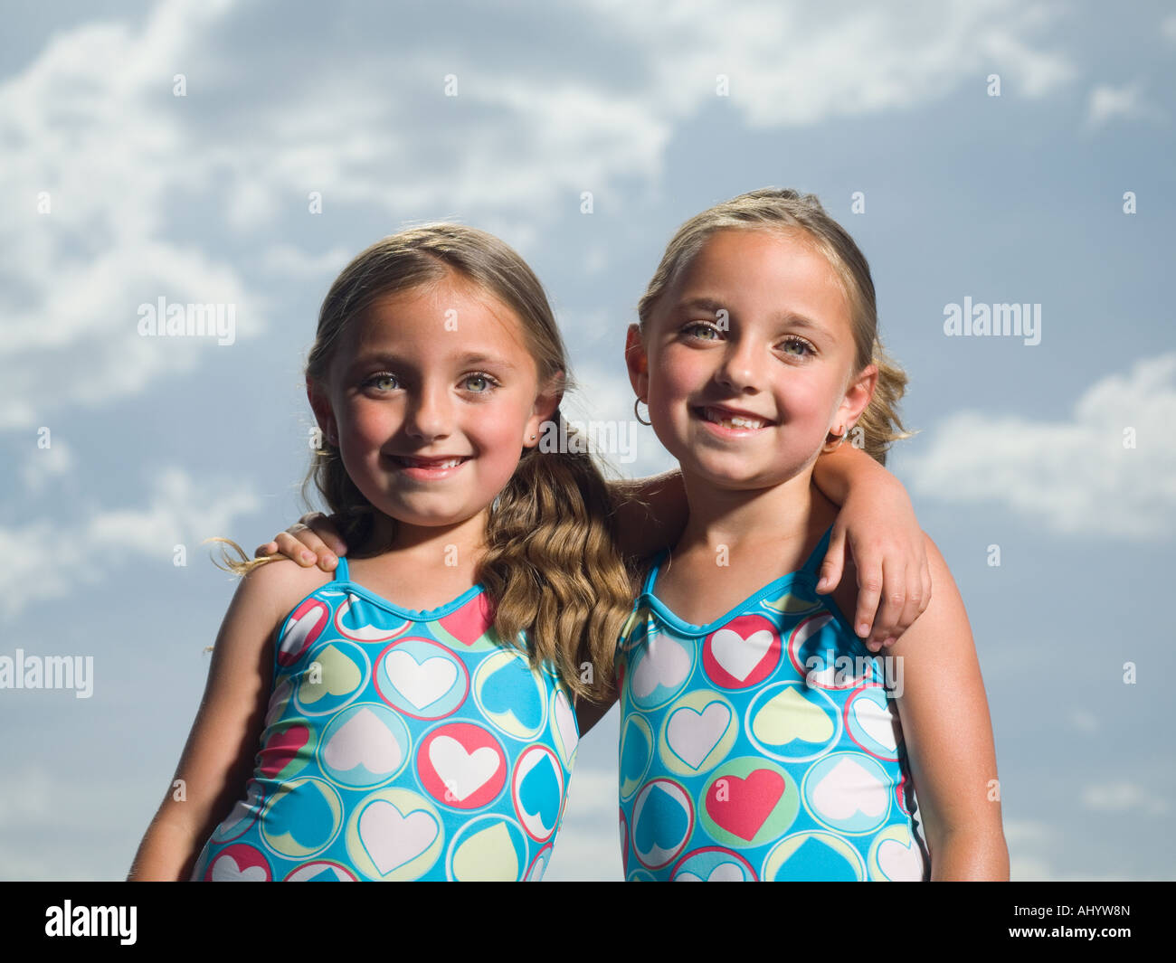 Two Smiling Twin Sisters Hugging High Resolution Stock Photography and ...