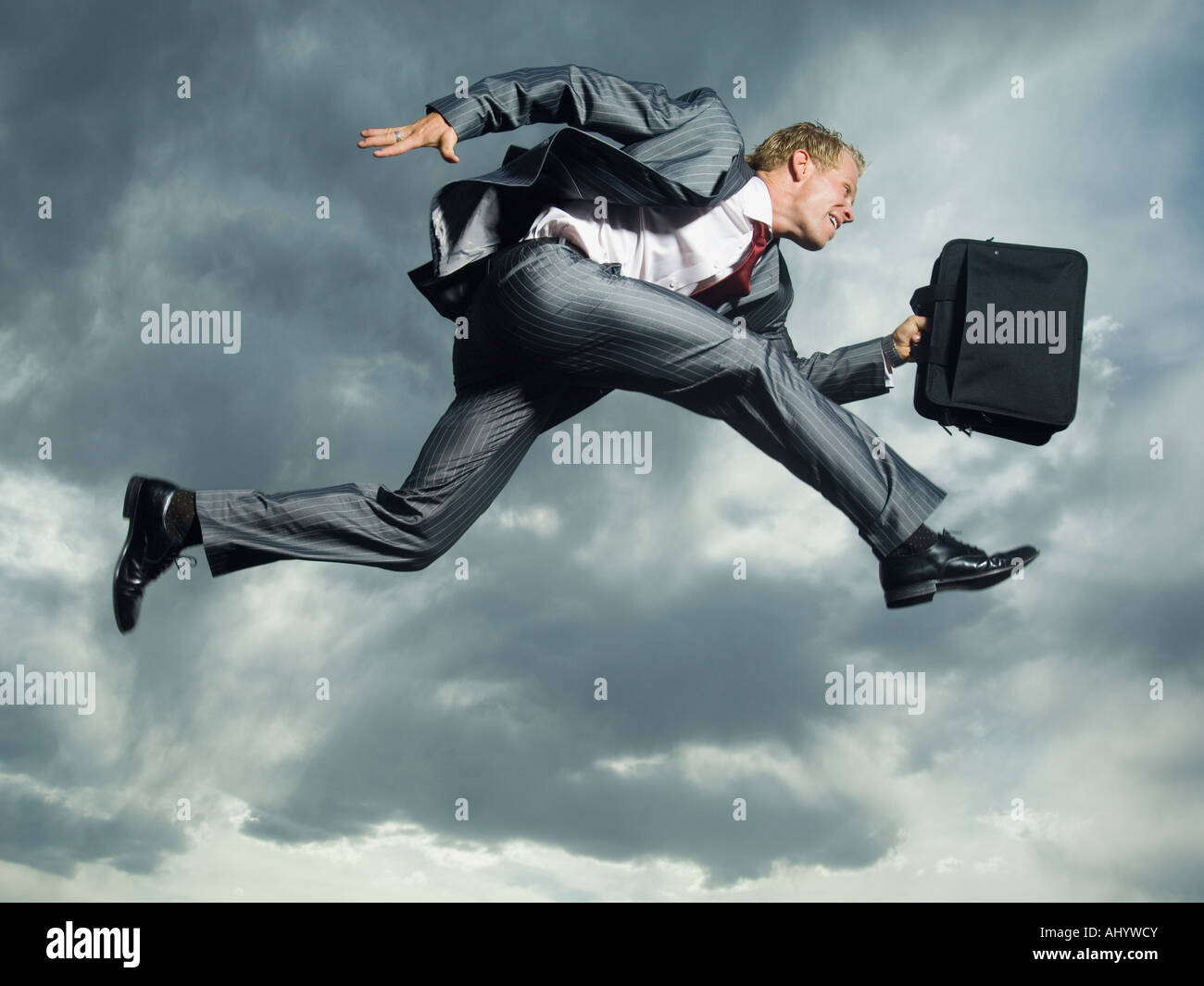 Low angle view of businessman jumping Stock Photo - Alamy