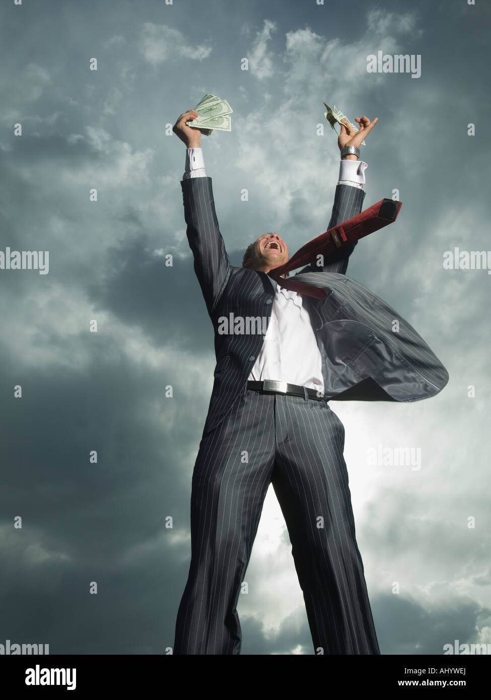 Low angle view of businessman cheering Stock Photo - Alamy